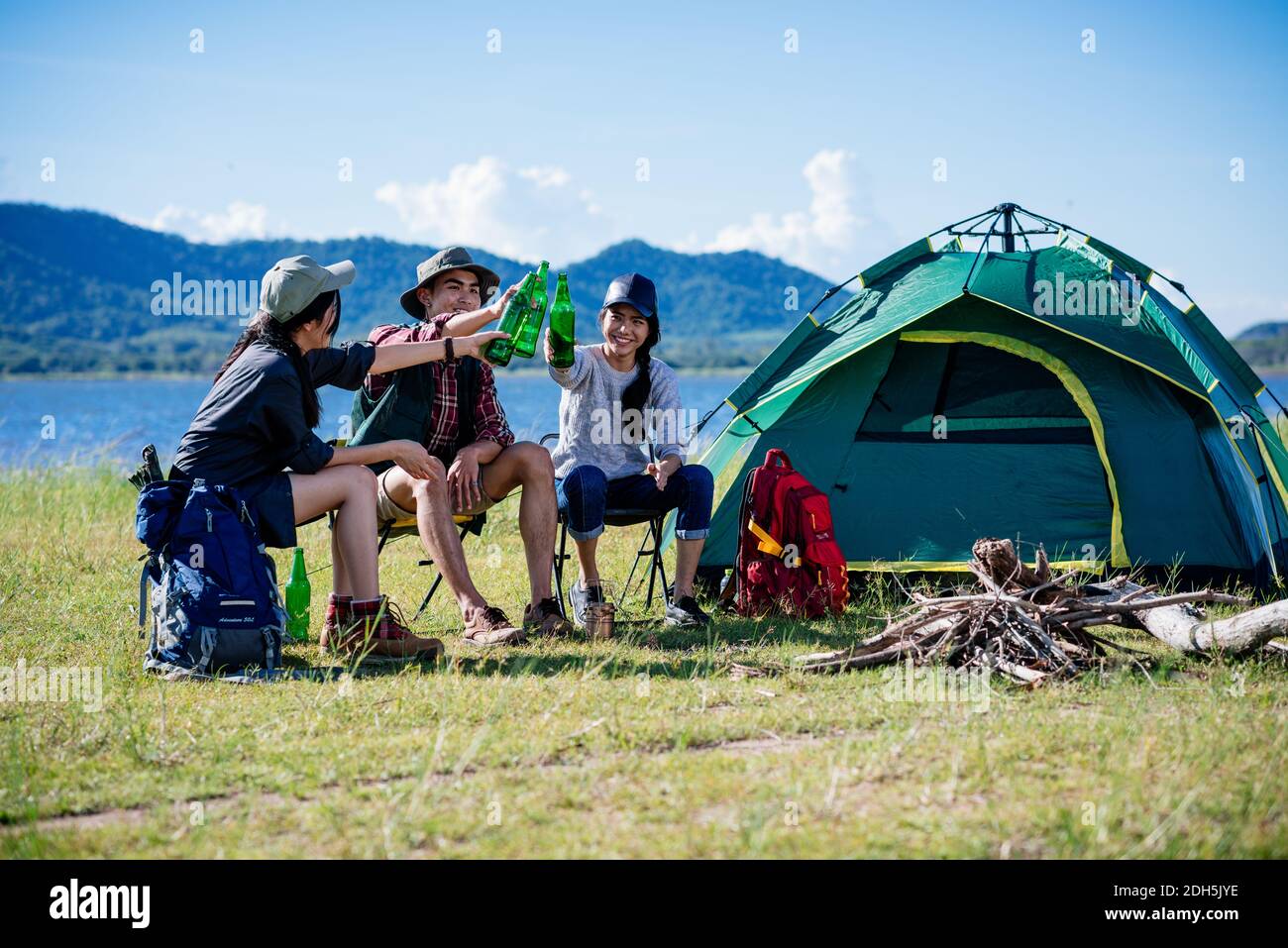 Camping camp in nature happy friends party and drinking beer together ...
