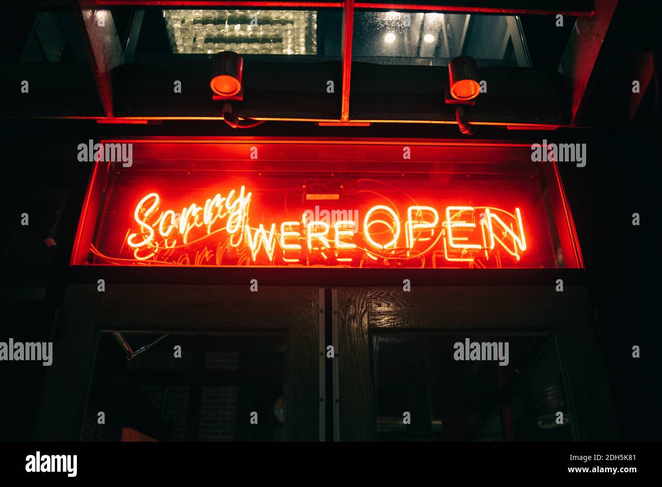 red sorry we're open signage at night with reflection Stock Photo - Alamy