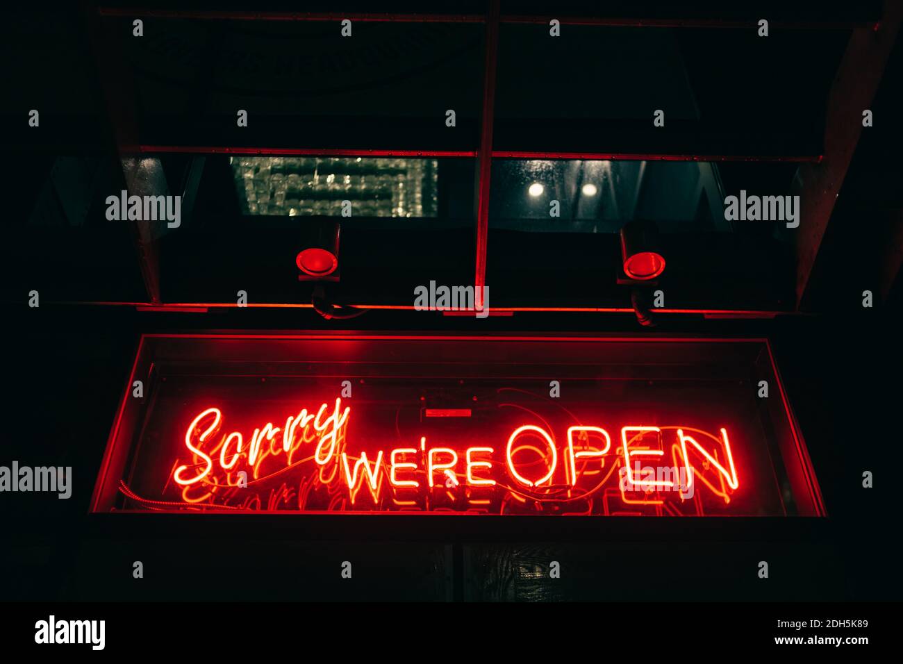 red sorry we're open signage at night with reflection Stock Photo - Alamy