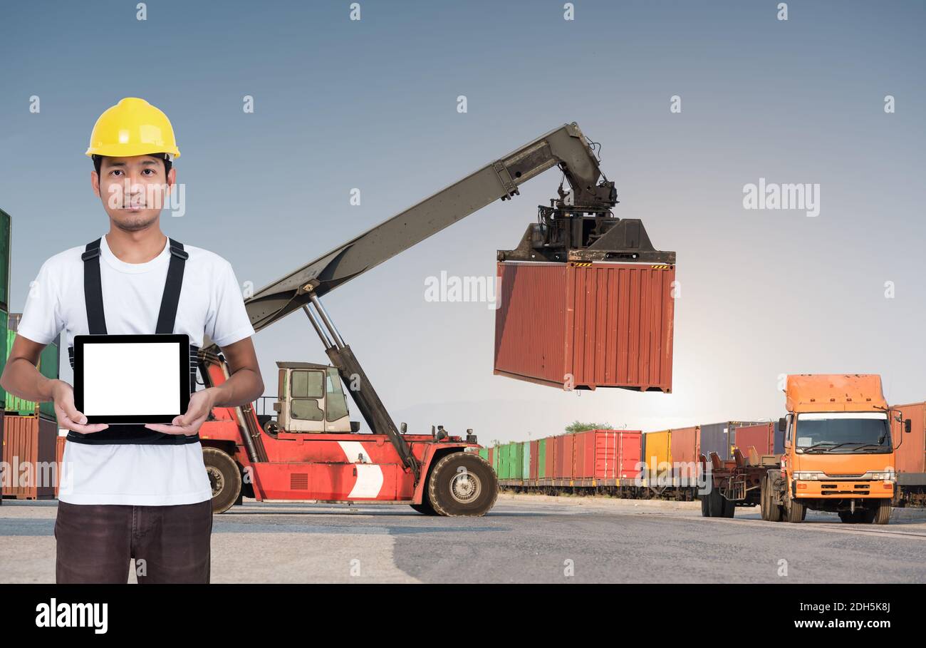Foreman stand show tablet on front forklift loading Containers box to ...