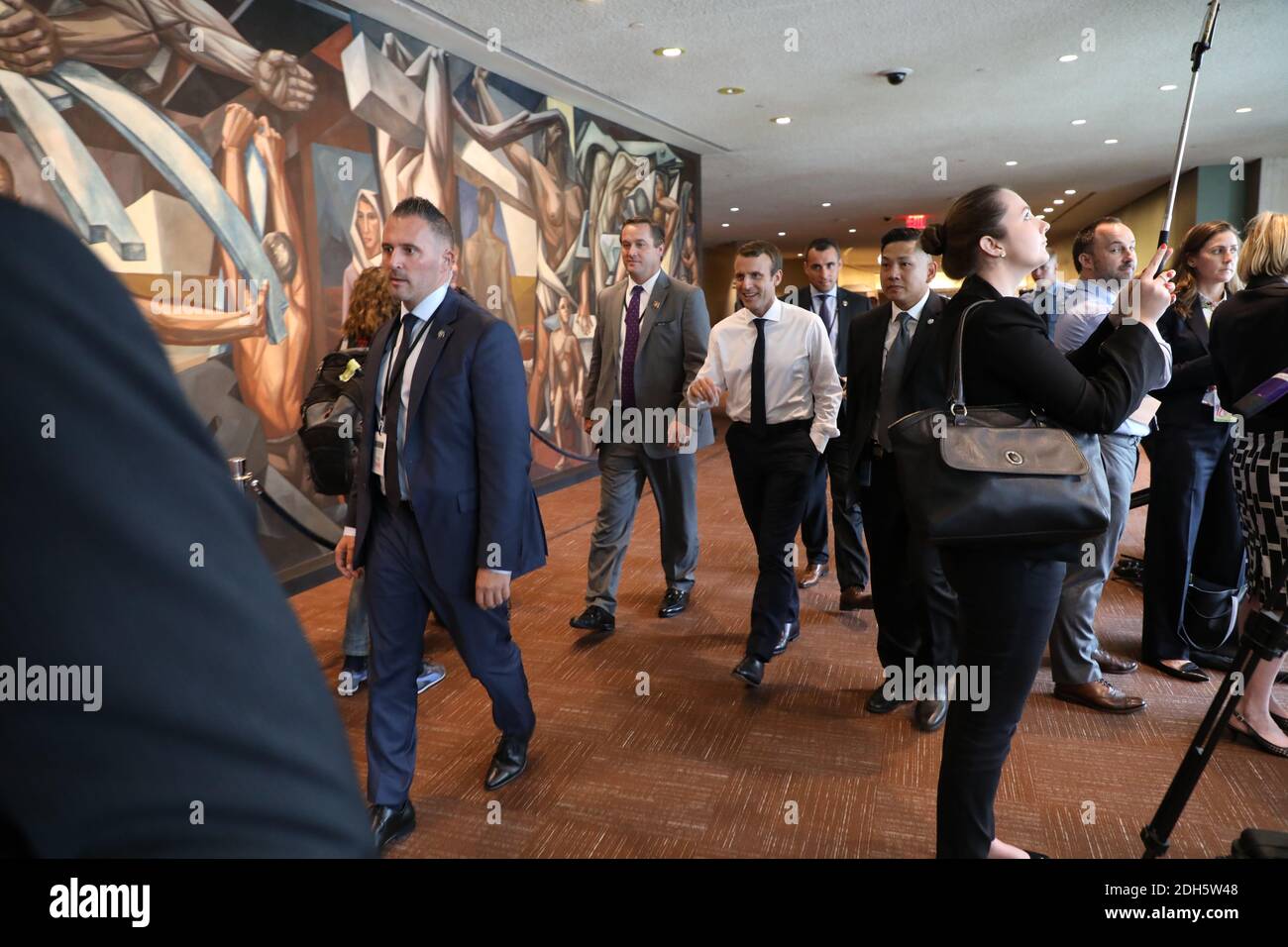 French President Emmanuel Macron walks from his office to a meeting at ...