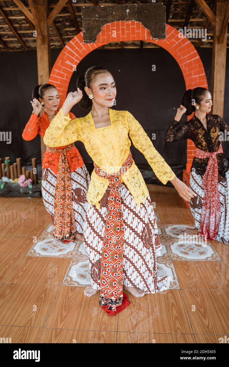 portrait of three young women presenting traditional Javanese dance ...