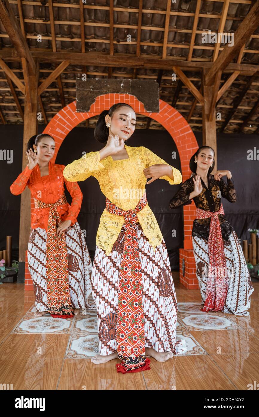 portrait of three young women presenting traditional Javanese dance ...