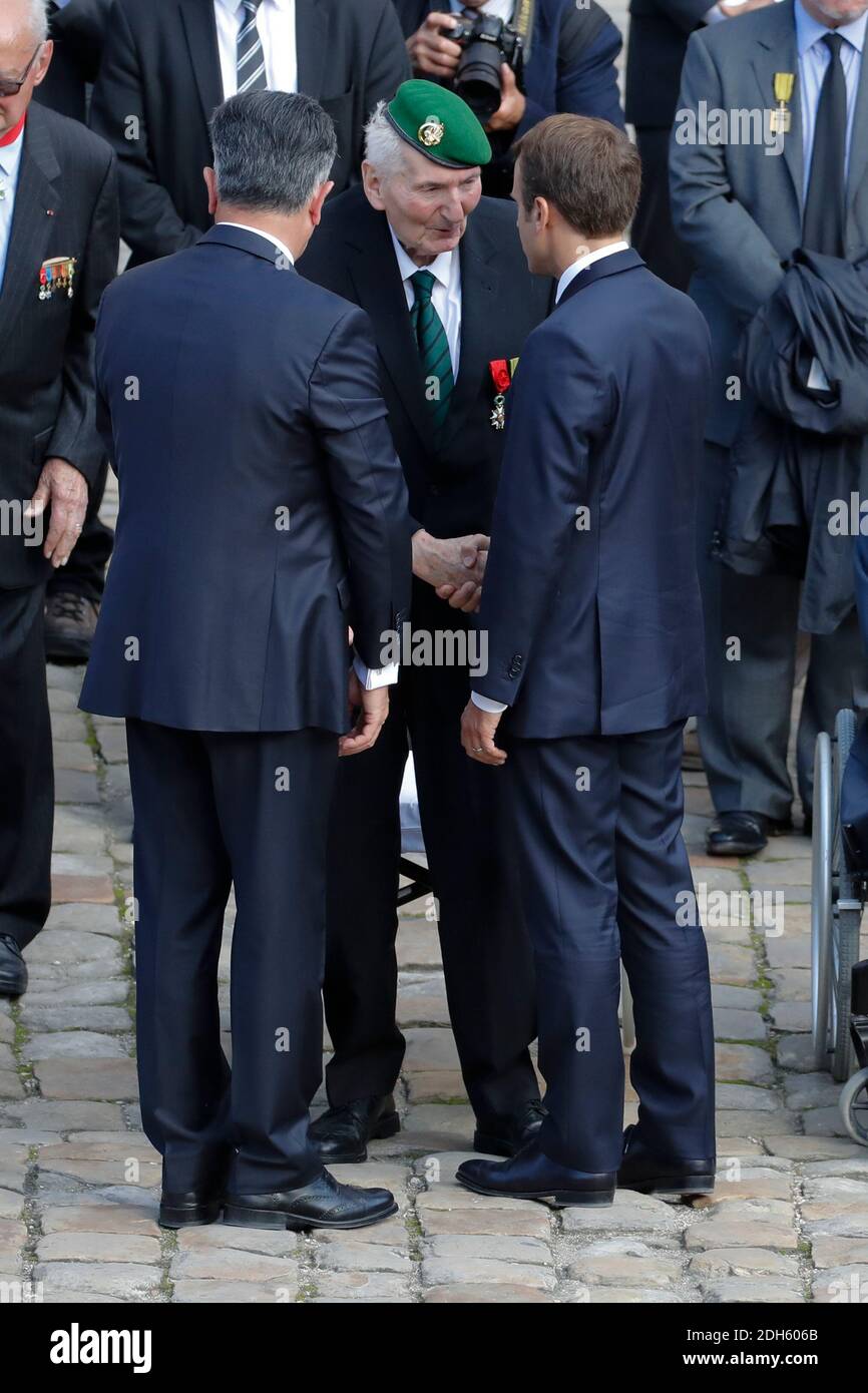 French President Emmanuel Macron shakes hand with Hubert Germain, one ...