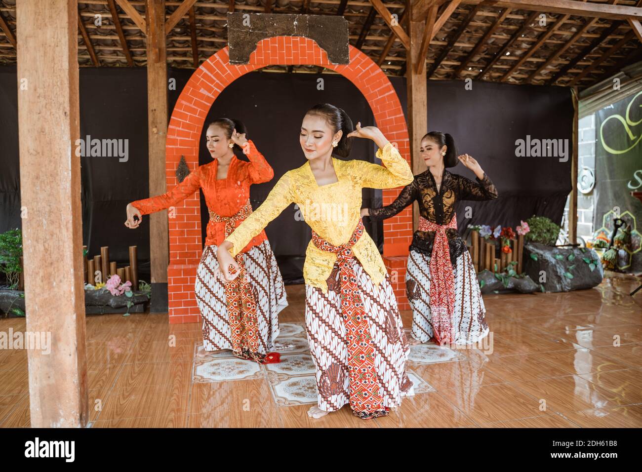 portrait of three young women presenting traditional Javanese dance ...