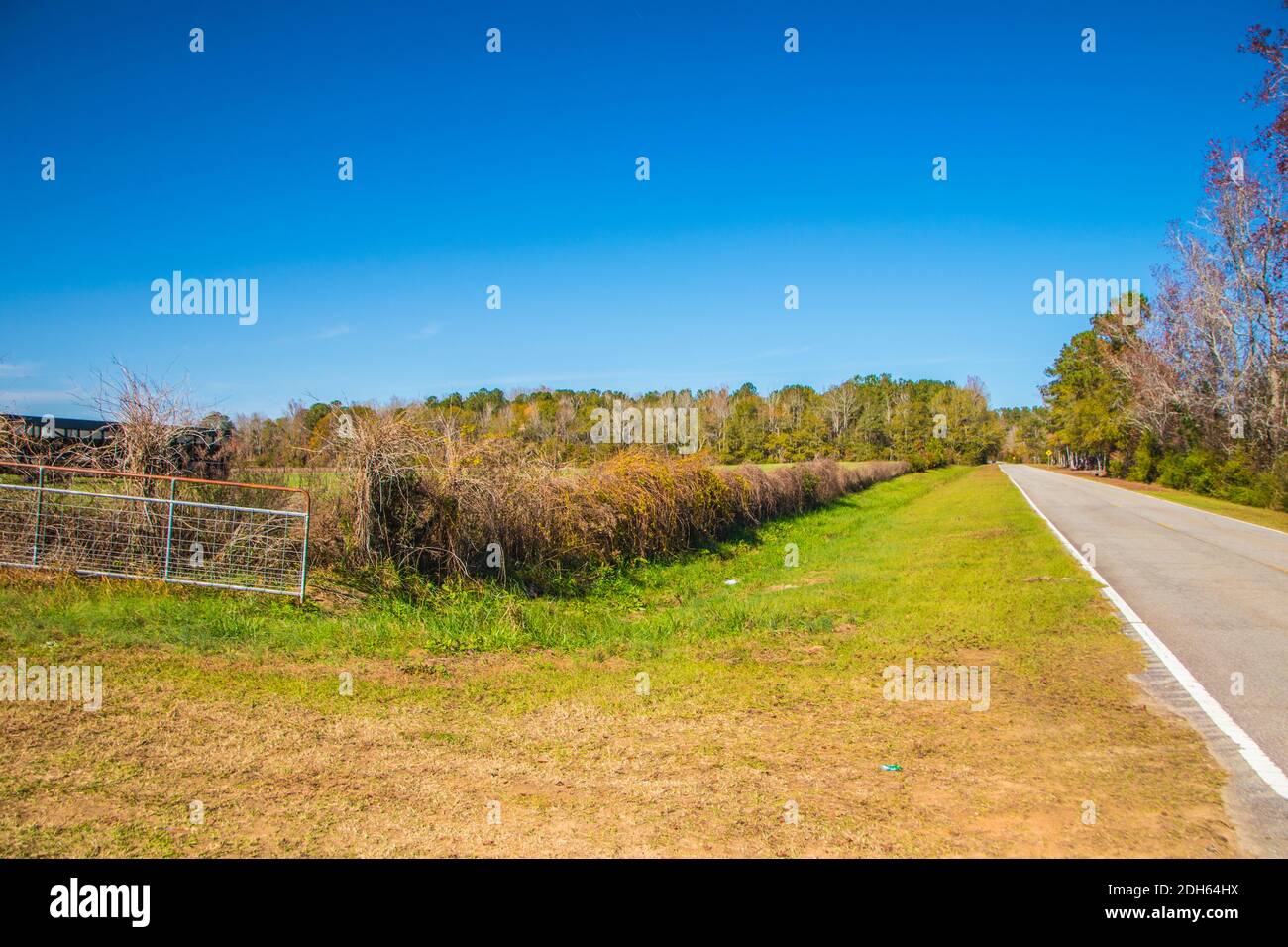 Road in the country with beautiful Fall colors and farm land scene ...