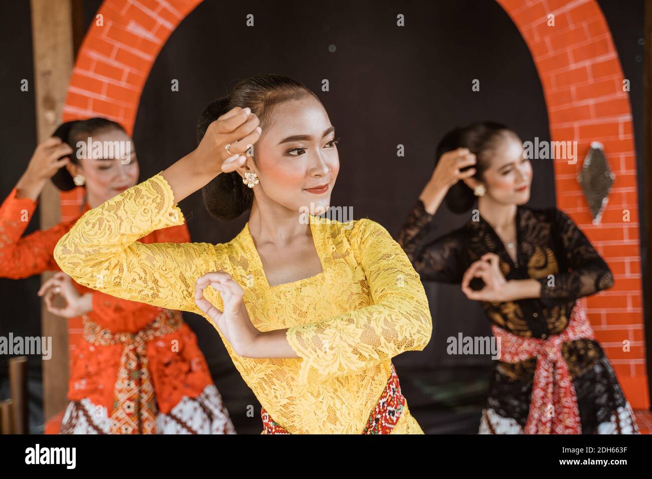 portrait of three young women presenting traditional Javanese dance ...