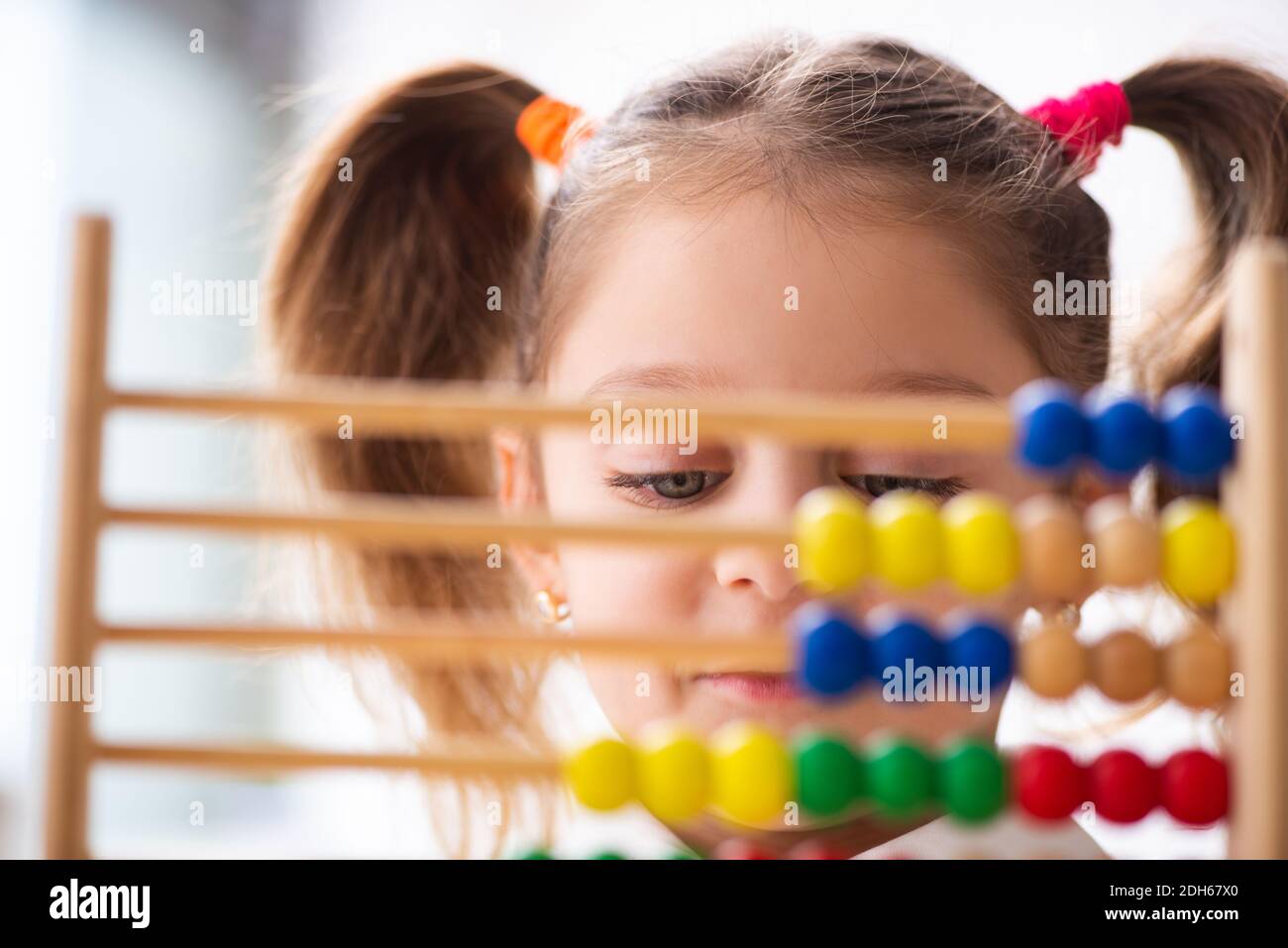 Small girl with abacus in the classroom Stock Photo - Alamy