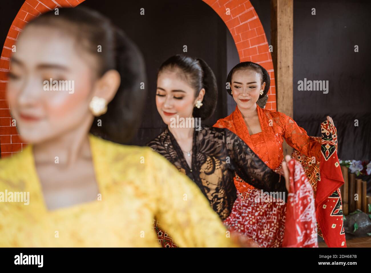 portrait of three young women presenting traditional Javanese dance ...