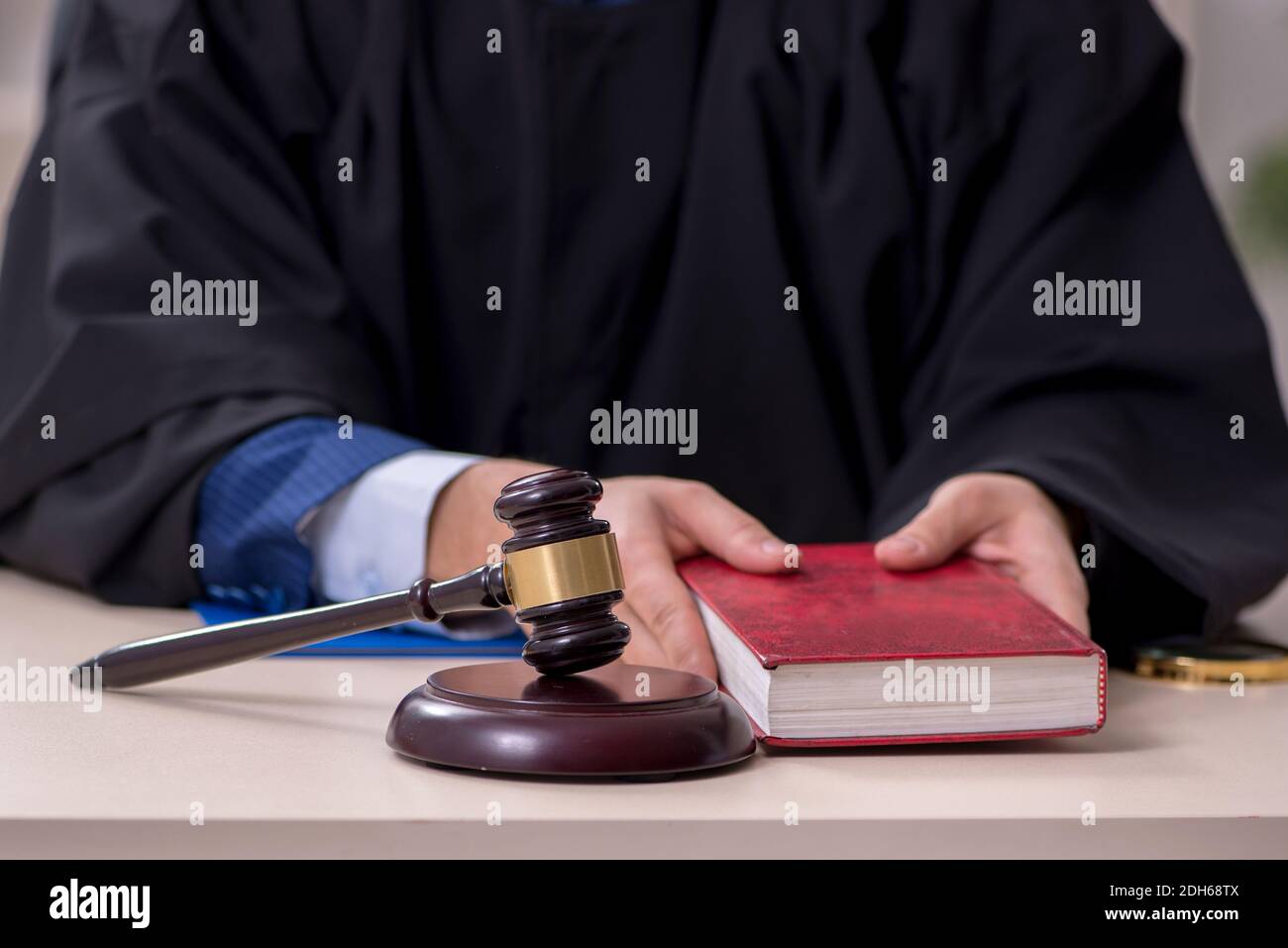 Young male judge working in courthouse Stock Photo - Alamy