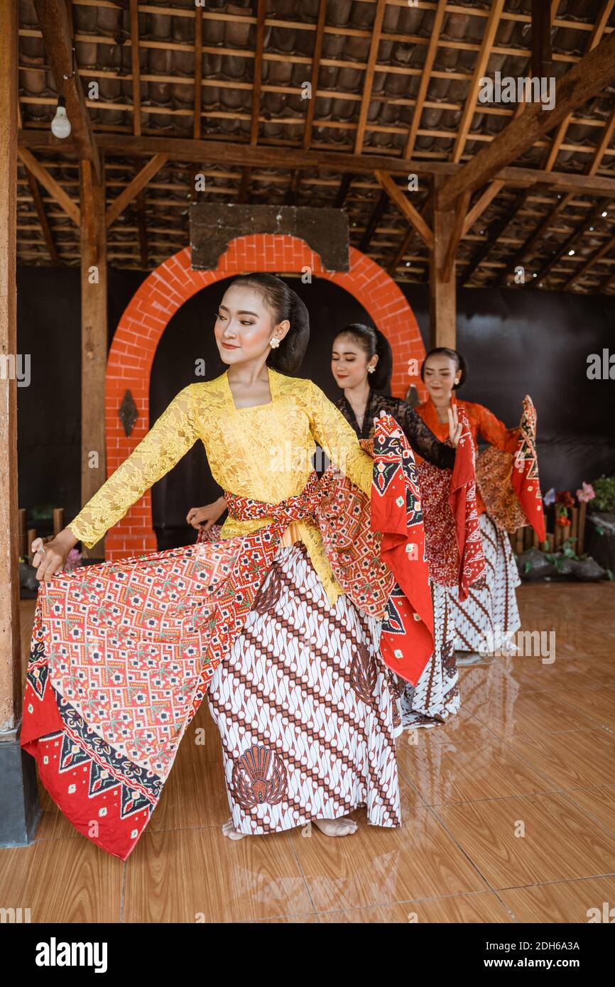 portrait of three young women presenting traditional Javanese dance ...