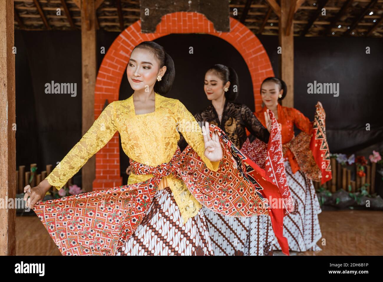 portrait of three young women presenting traditional Javanese dance ...