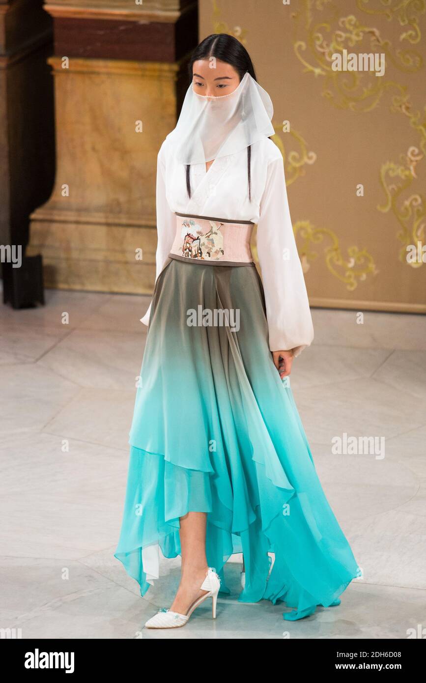 A models displays a creation designed by Ying Xiong on the runway ...