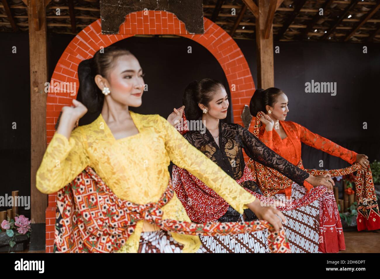 portrait of three young women presenting traditional Javanese dance ...