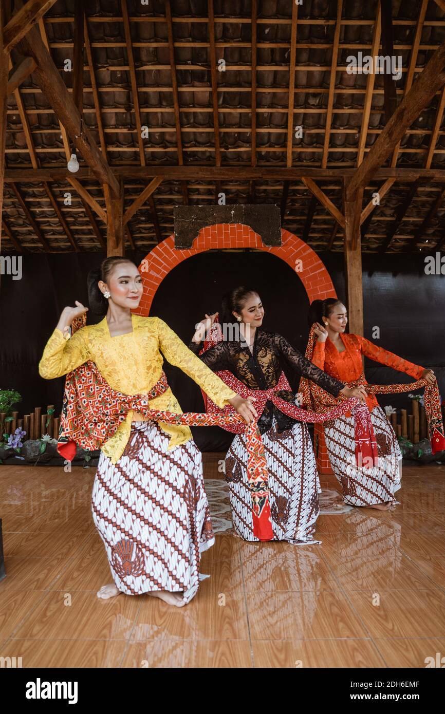 portrait of three young women presenting traditional Javanese dance ...