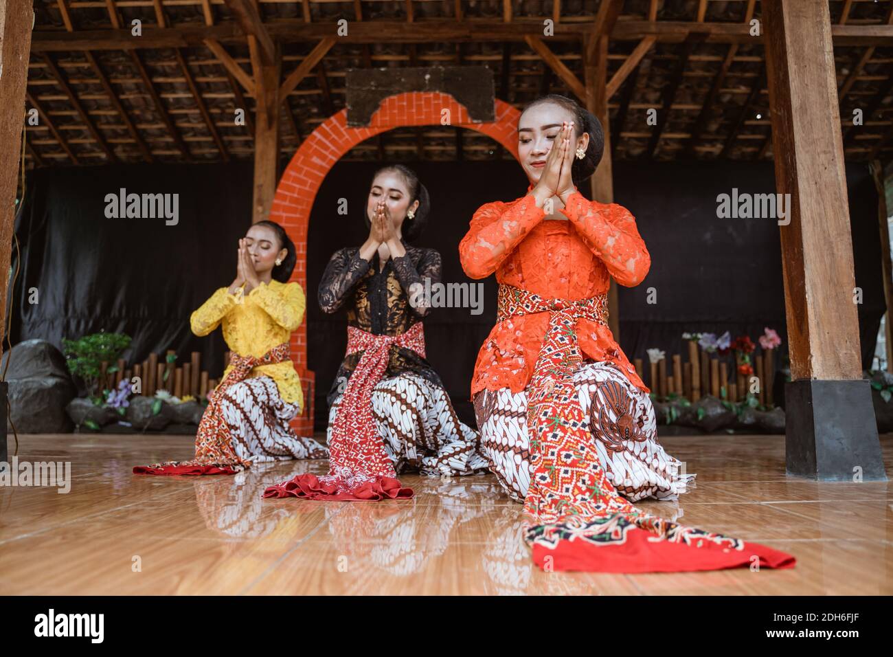 portrait of three young women presenting traditional Javanese dance ...