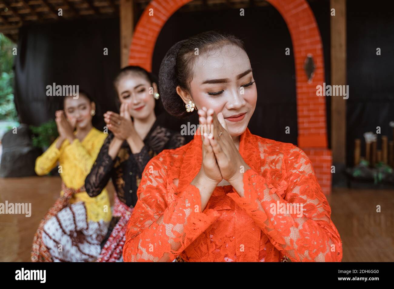 portrait of three young women presenting traditional Javanese dance ...