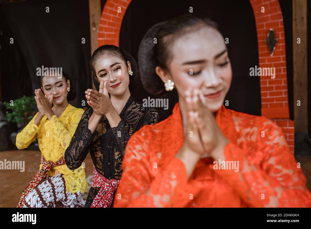 portrait of three young women presenting traditional Javanese dance ...