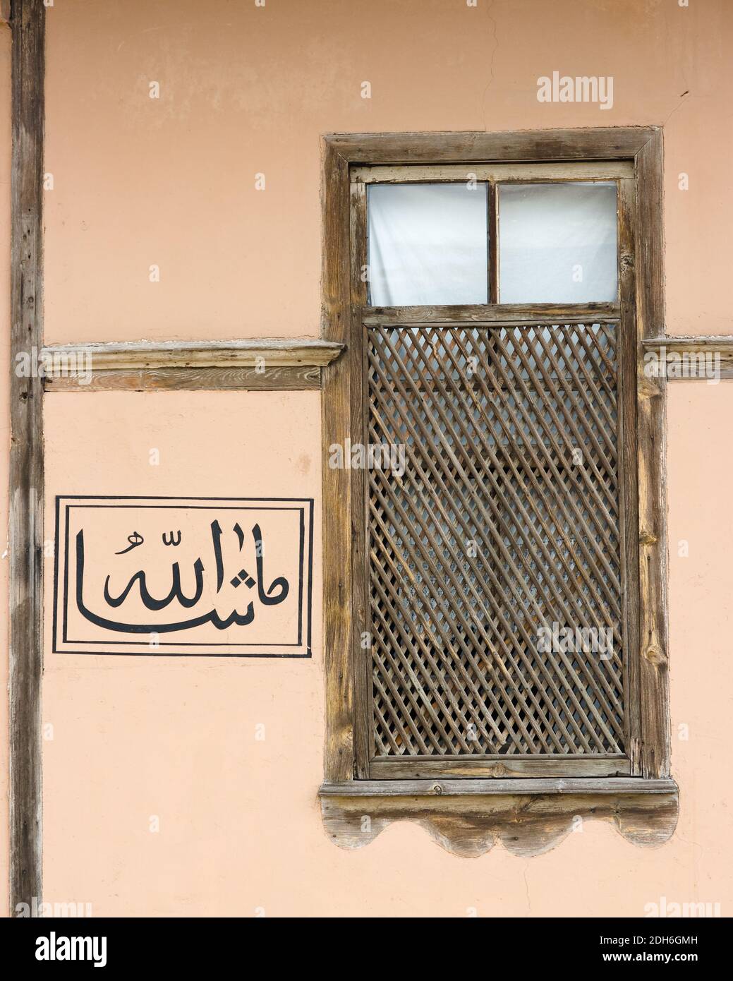arabic calligraphy and typical wooden window on facade of ottoman house ...