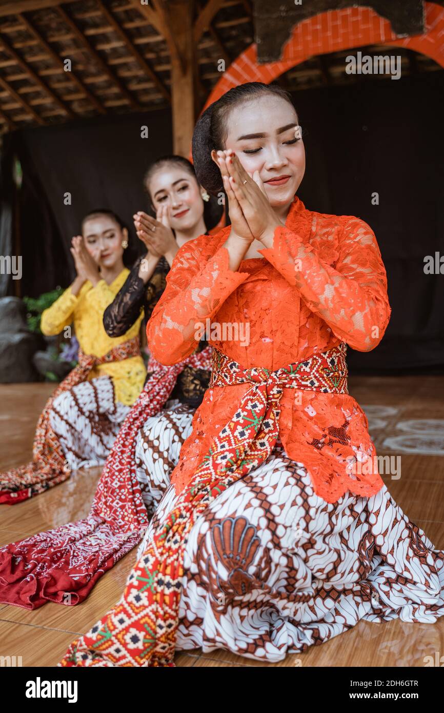 portrait of three young women presenting traditional Javanese dance ...