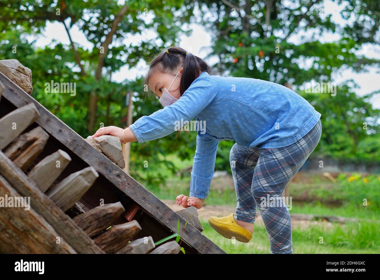 Girl Crawling Up A Hill
