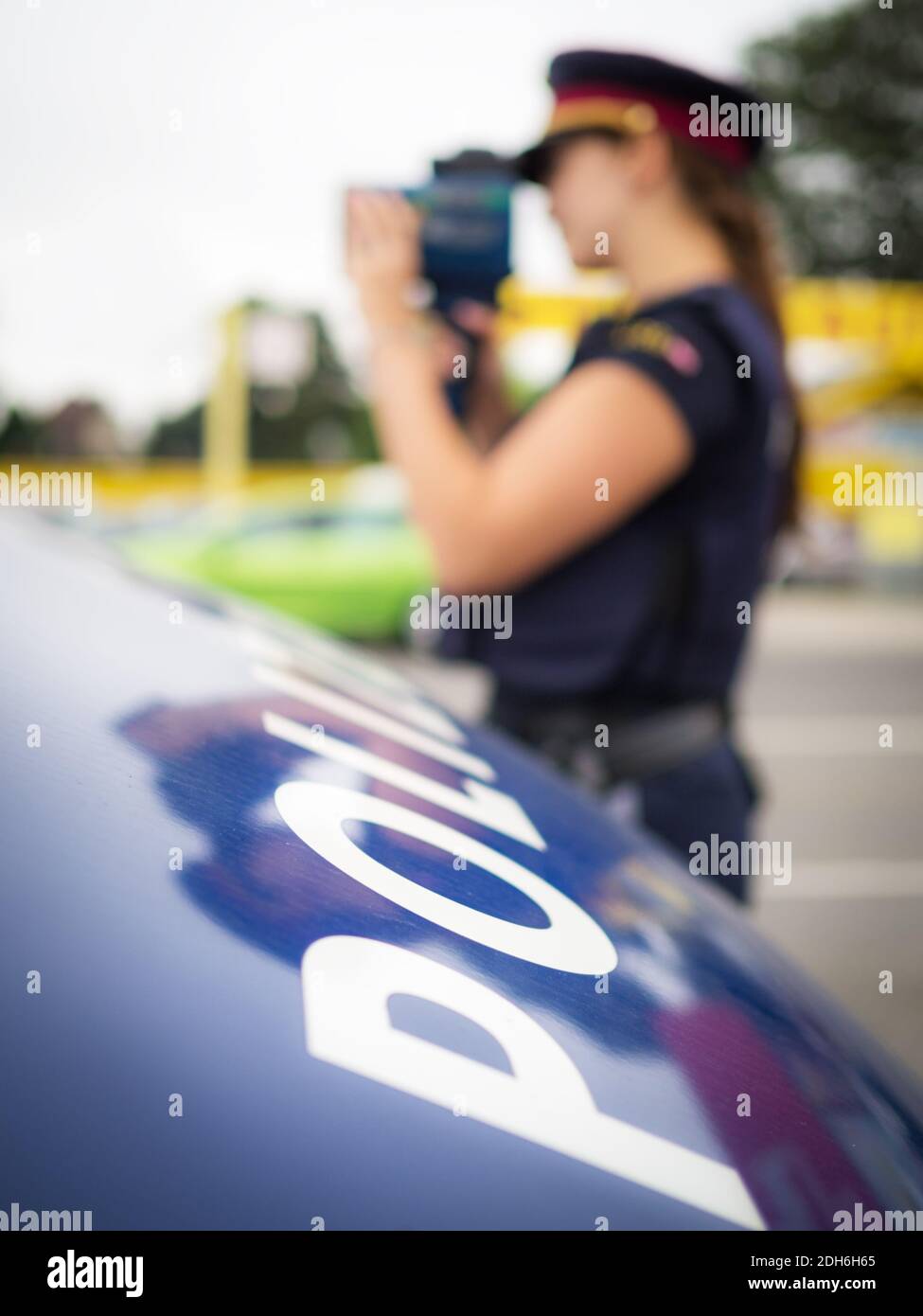 Female police officer with laser gun hunting for speeder Stock Photo ...
