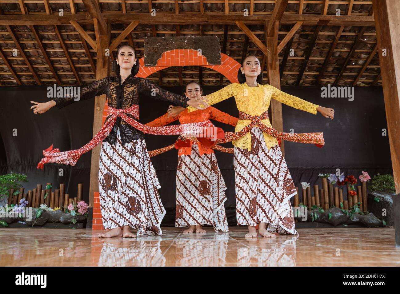portrait of three young women presenting traditional Javanese dance ...