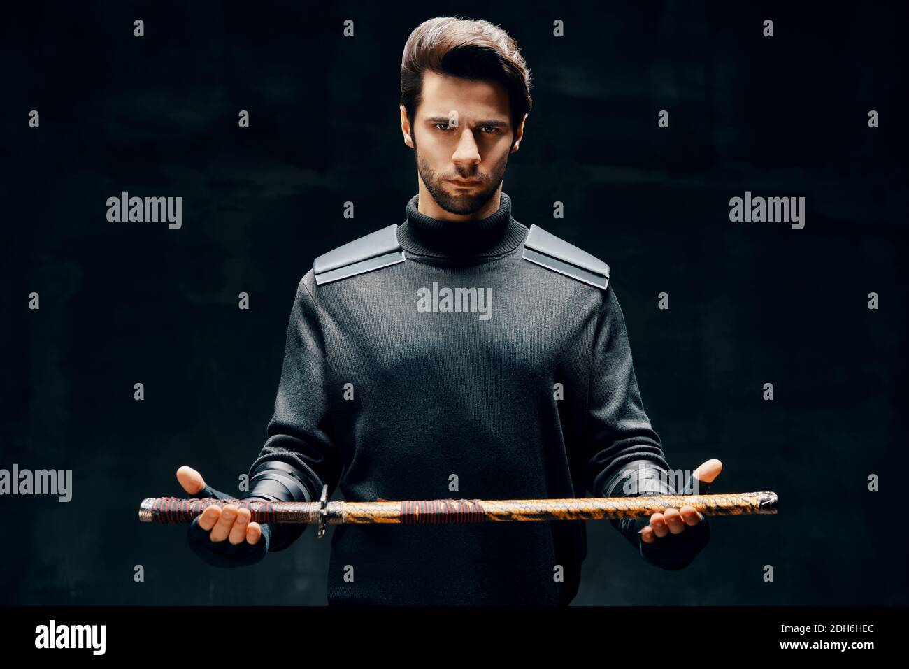 Warrior man posing with a sword Stock Photo - Alamy