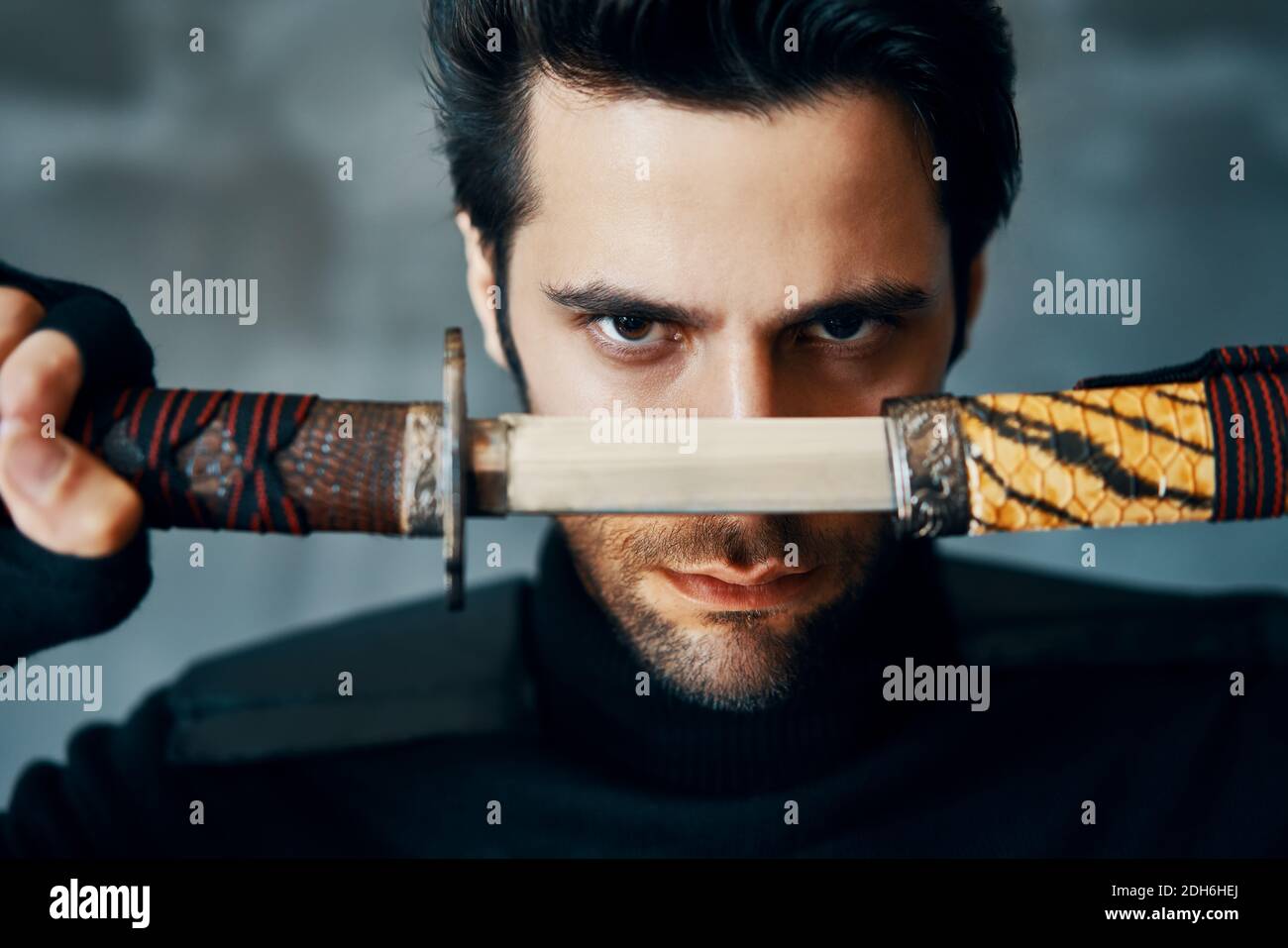 Warrior man posing with a sword Stock Photo - Alamy