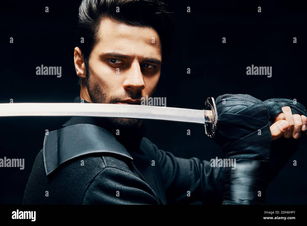 Warrior man posing with a sword Stock Photo - Alamy