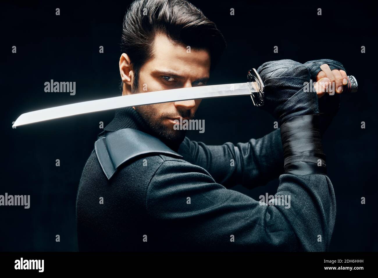 Warrior man posing with a sword ready to stab enemy Stock Photo - Alamy