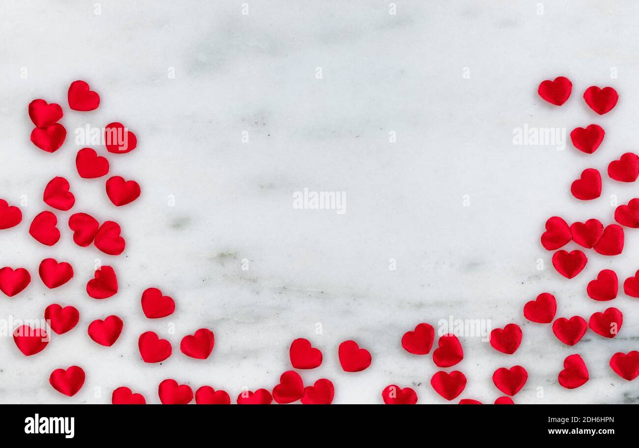 Red lovely hearts on natural marble stone in flay lay composition for ...