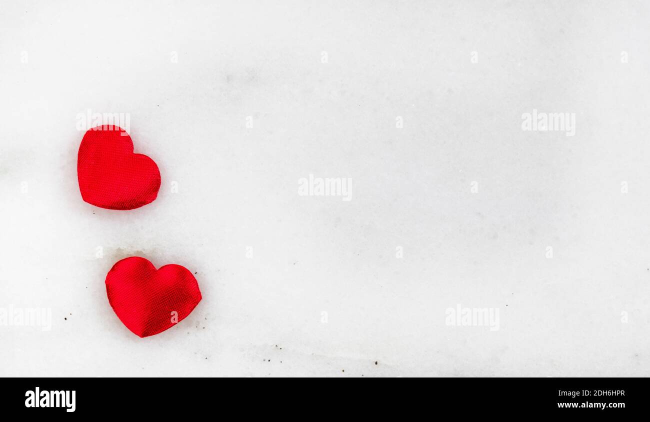 Two red lovely hearts on natural marble stone for Valentines Day ...