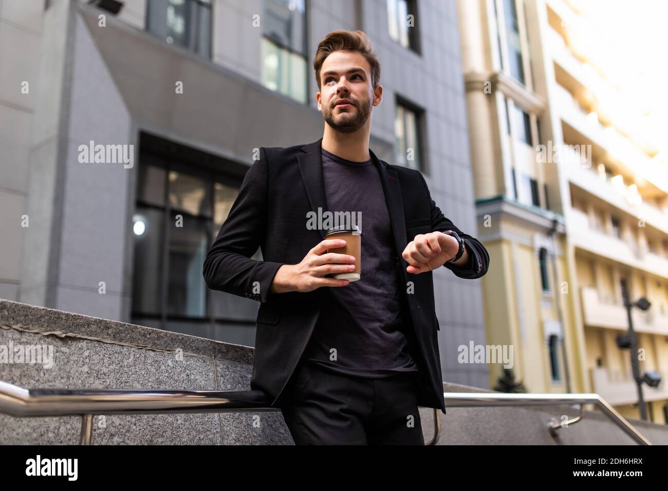 What time is it. Professional businessman going to work while checking ...