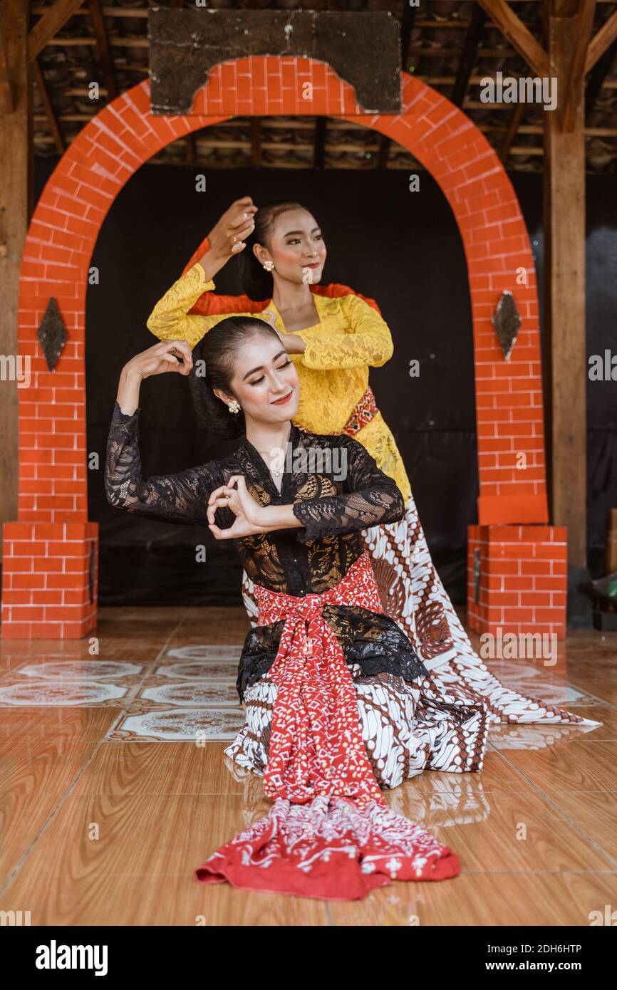 portrait of three young women presenting traditional Javanese dance ...