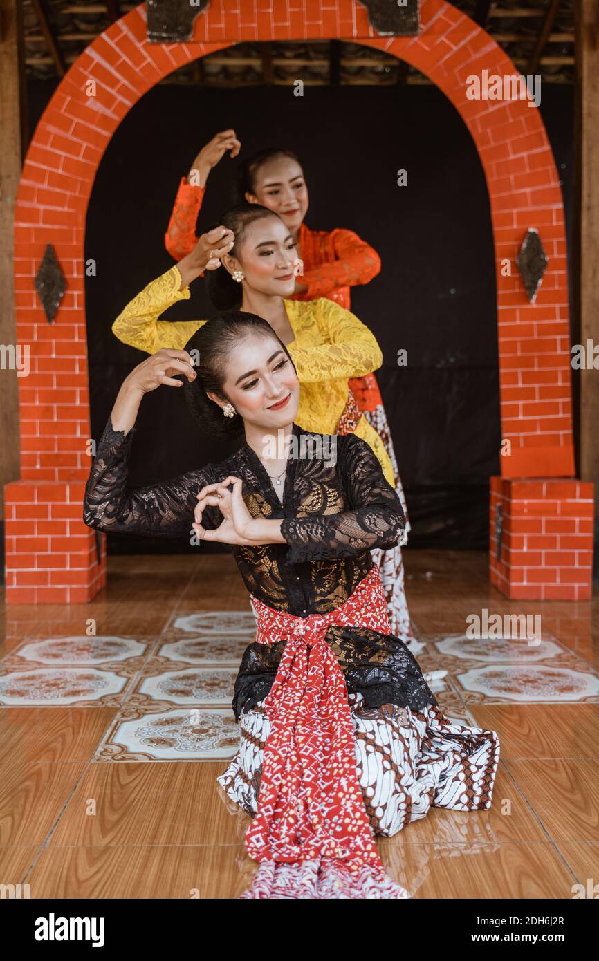 portrait of three young women presenting traditional Javanese dance ...
