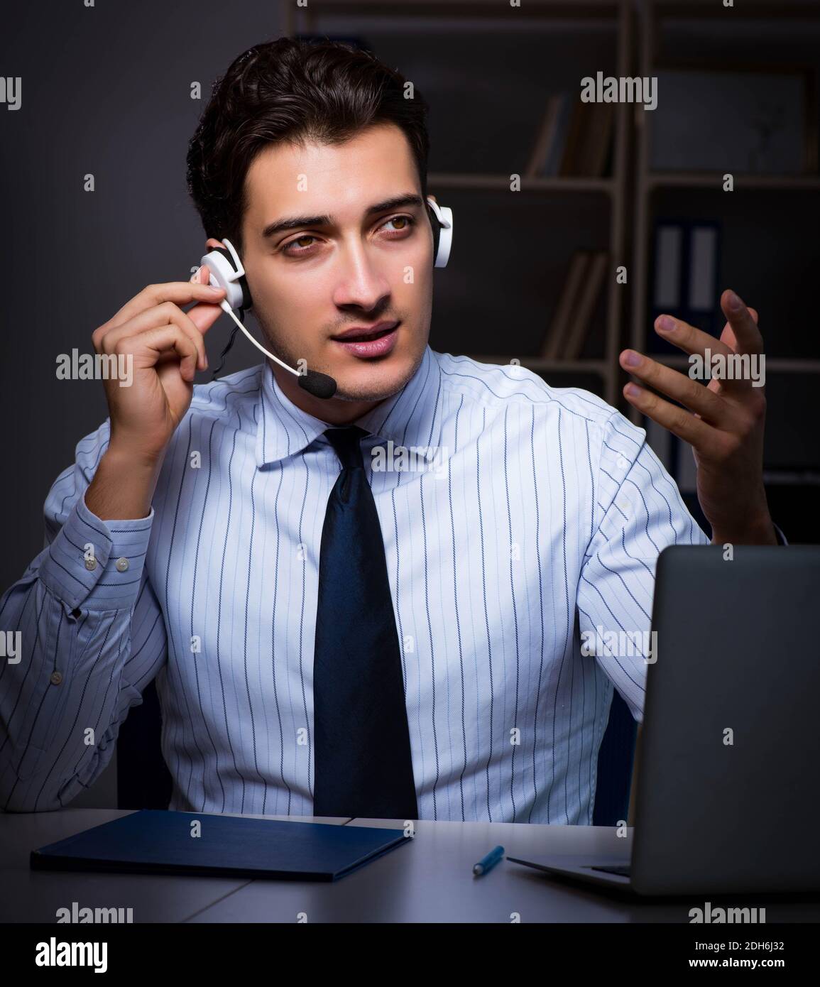 Call center operator talking to customer during night shift Stock Photo ...