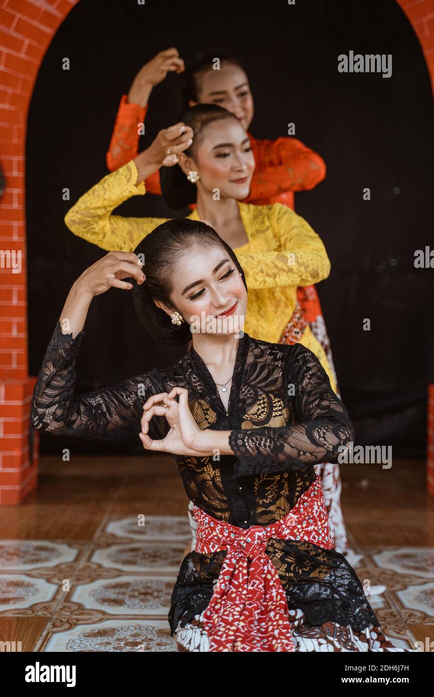 portrait of three young women presenting traditional Javanese dance ...