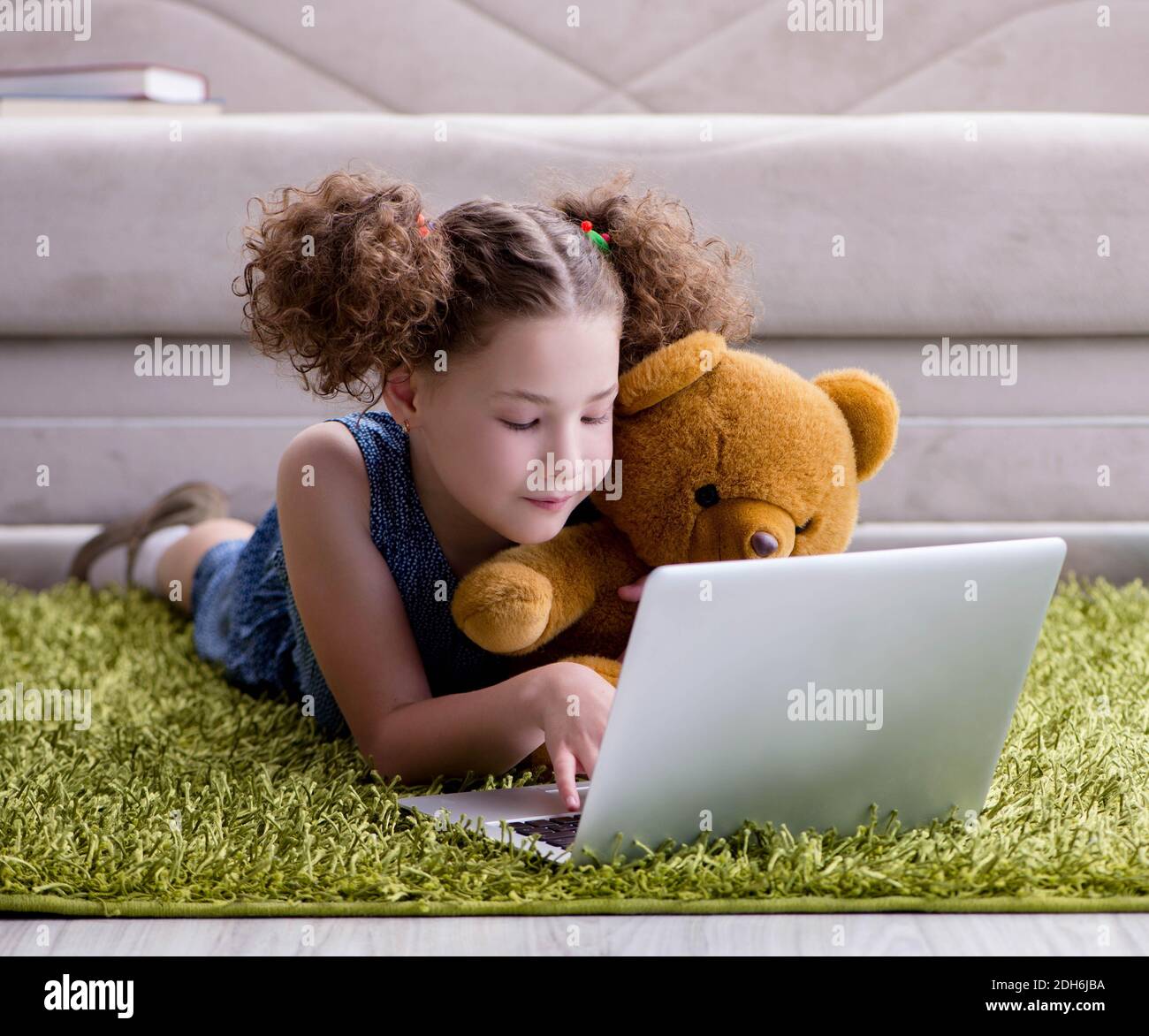 Little girl surfing internet on laptop Stock Photo - Alamy
