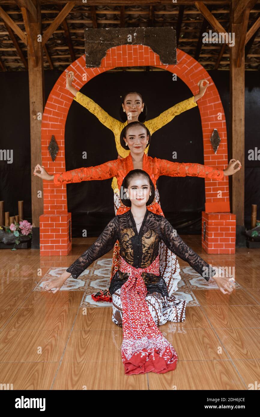 portrait of three young women presenting traditional Javanese dance ...
