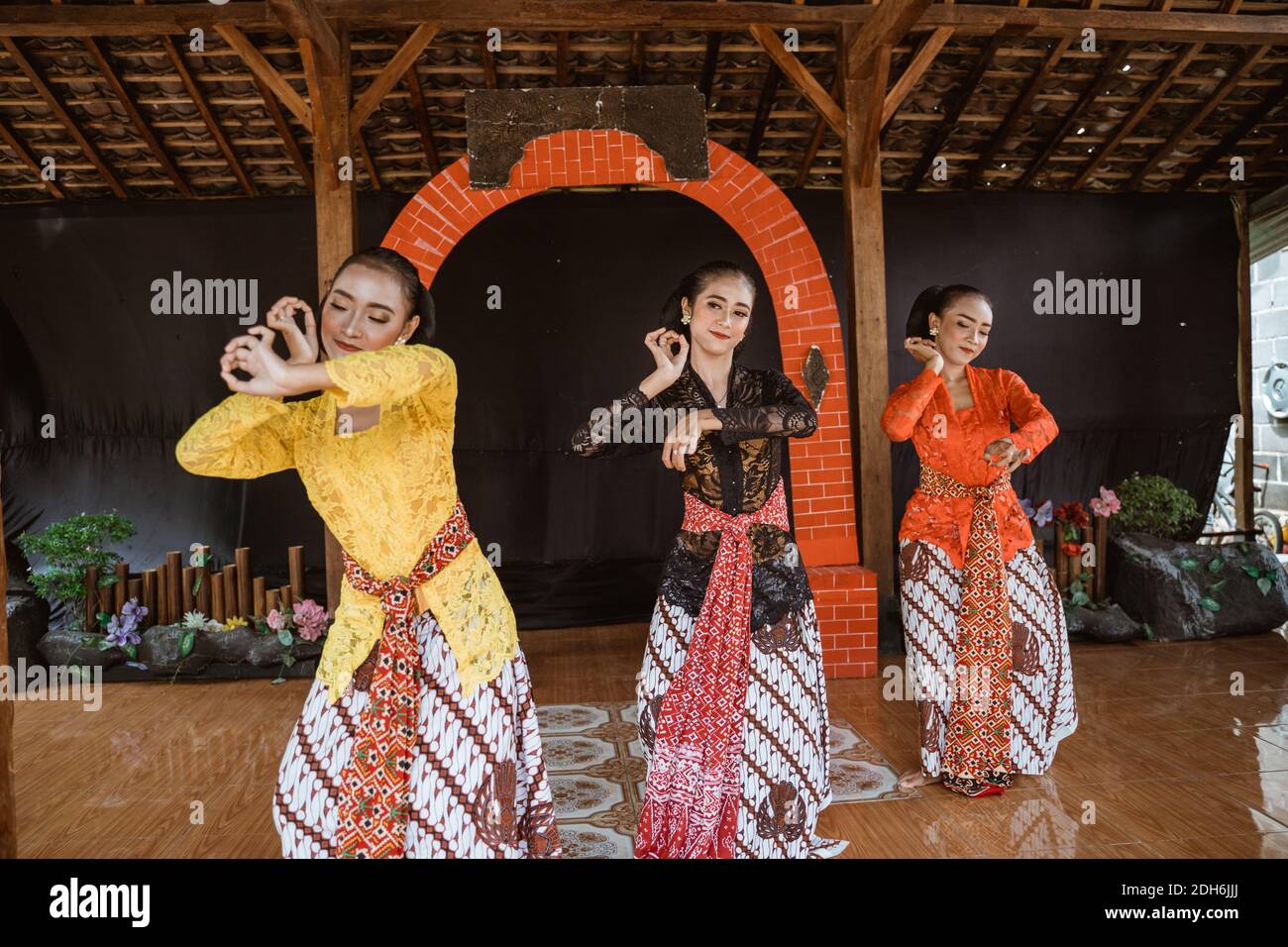portrait of three young women presenting traditional Javanese dance ...