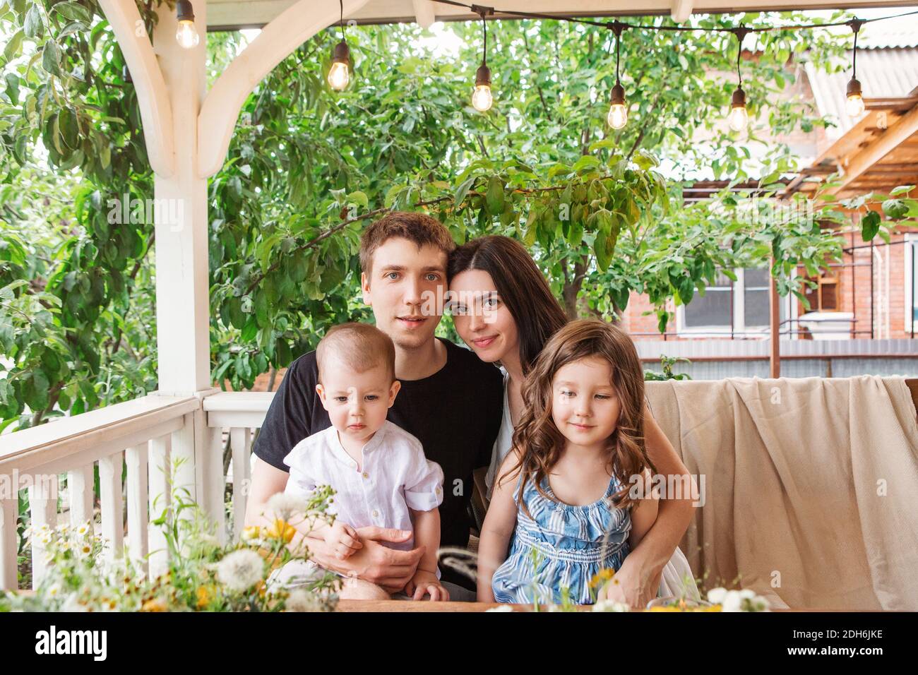 Happy family at table on terrace Stock Photo - Alamy