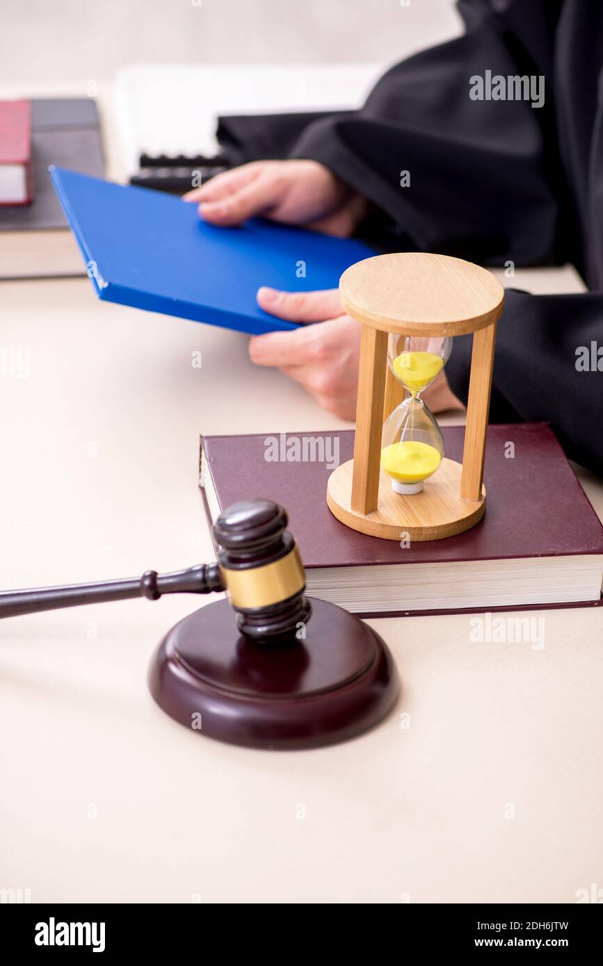 Young male judge in time management concept Stock Photo - Alamy