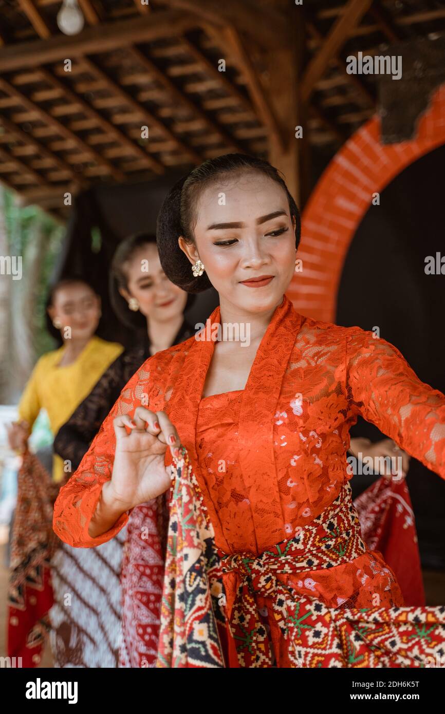 portrait of three young women presenting traditional Javanese dance ...