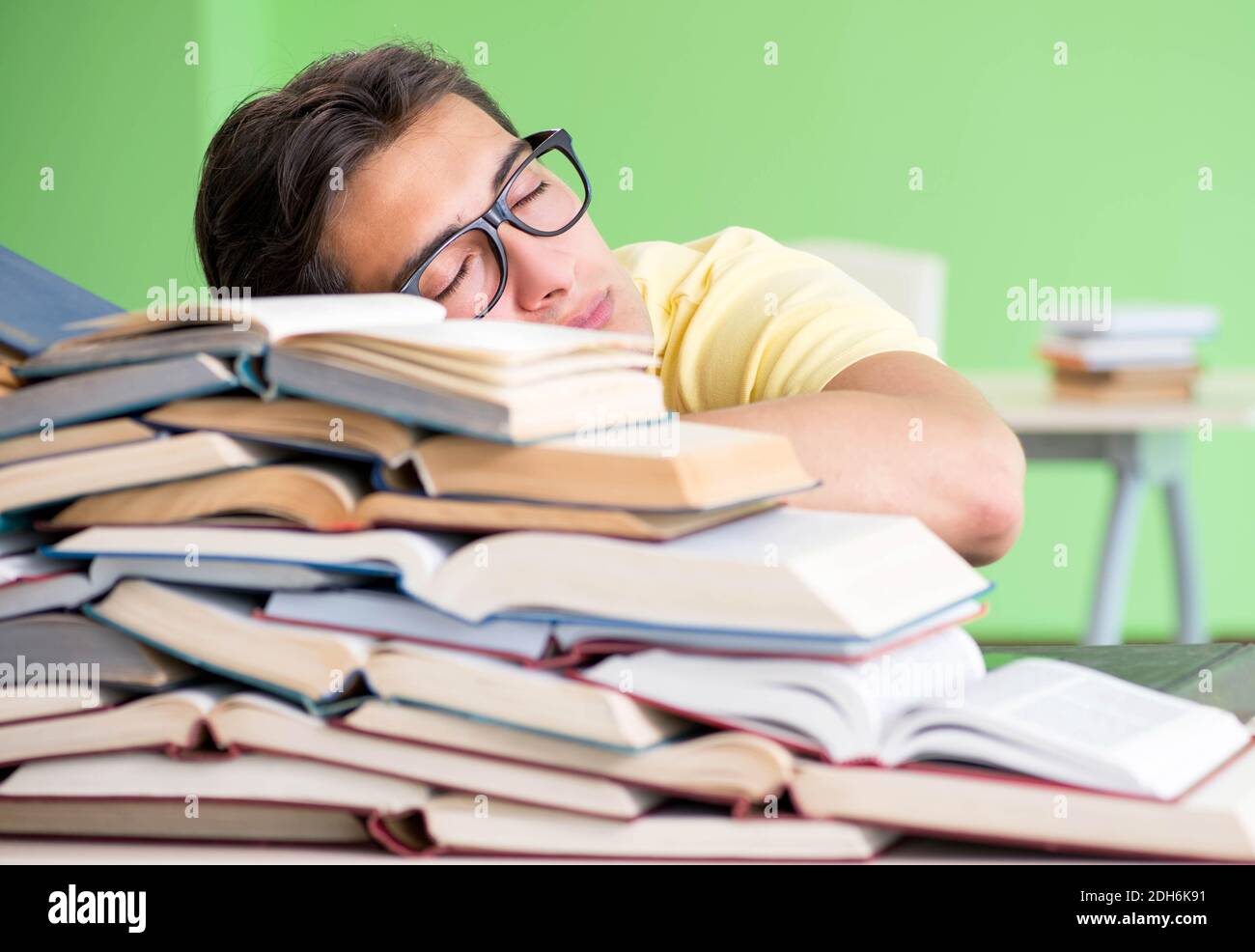 Student with too many books to read before exam Stock Photo - Alamy