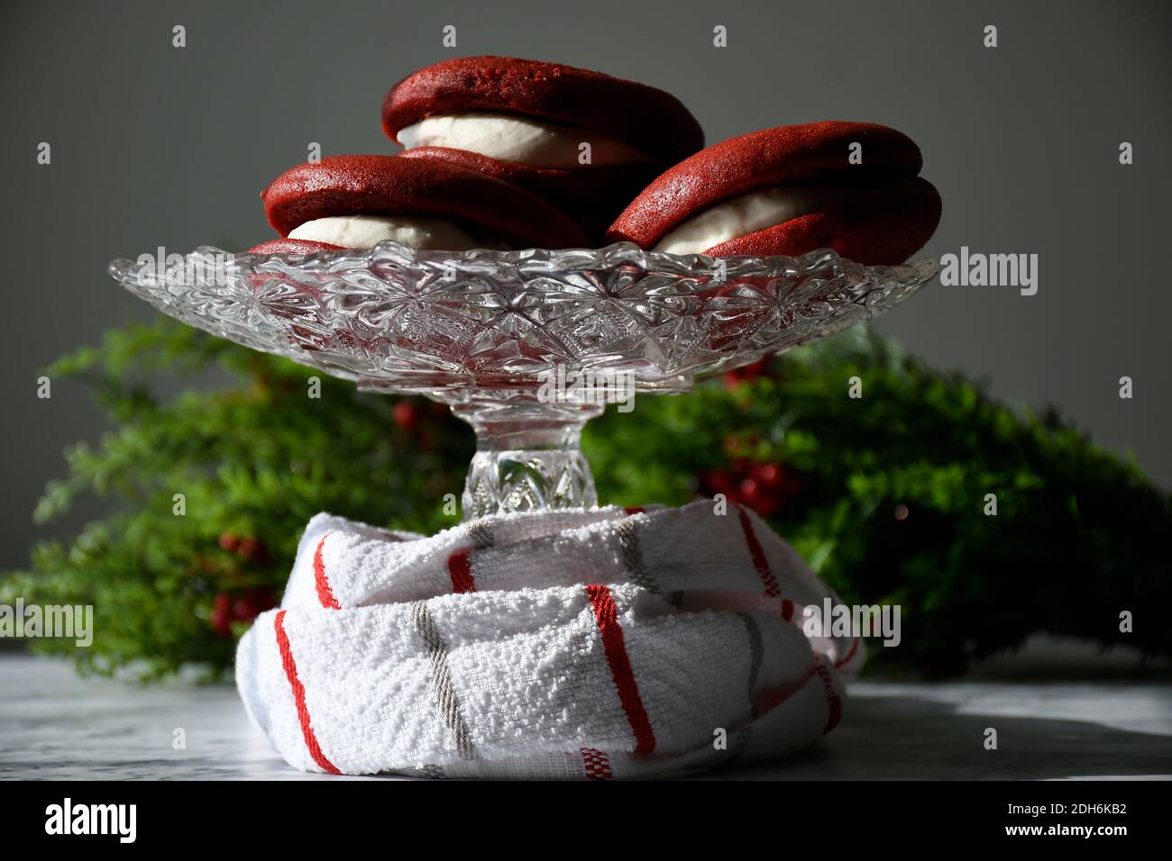 Food photography red velvet moon pies in crystal dish, holly branch in ...