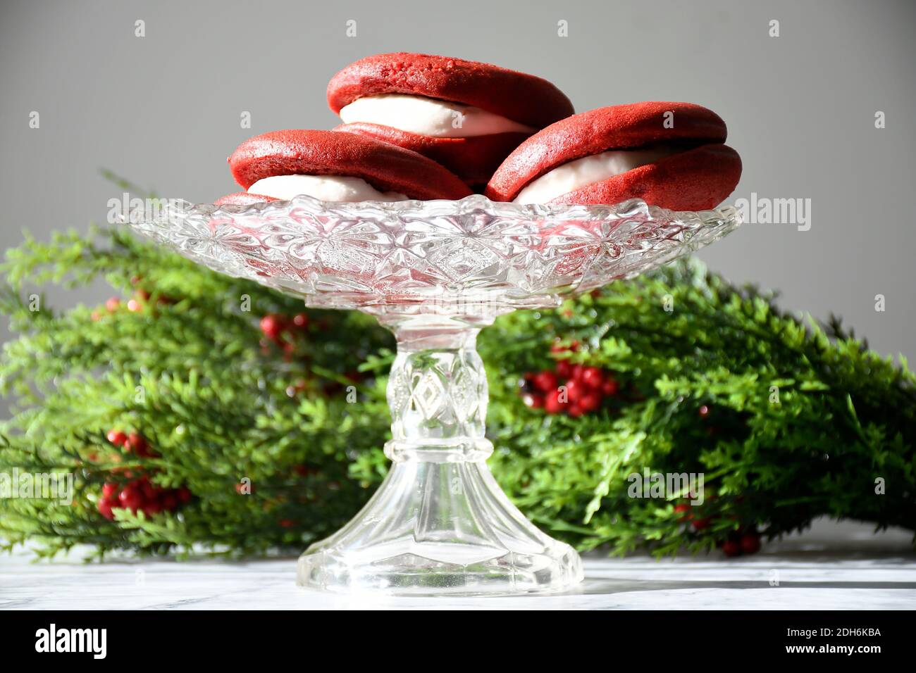 Food photography red velvet moon pies in crystal dish , holly branch in ...
