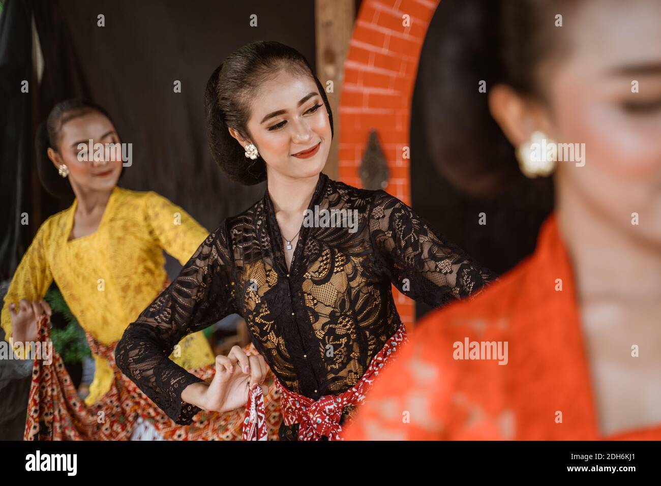 portrait of three young women presenting traditional Javanese dance ...