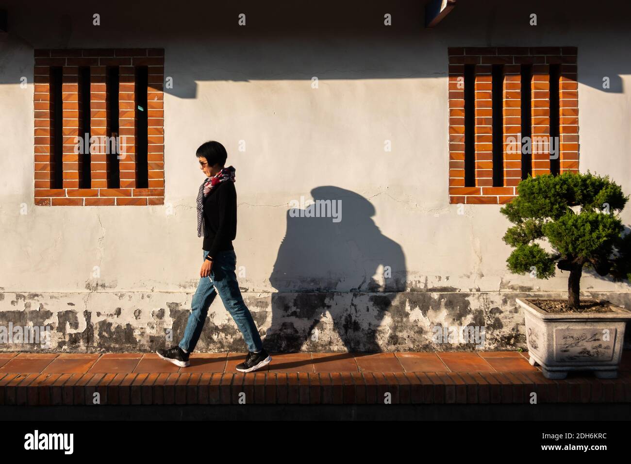 Woman walk at a traditional Chinese style old buildings Stock Photo - Alamy