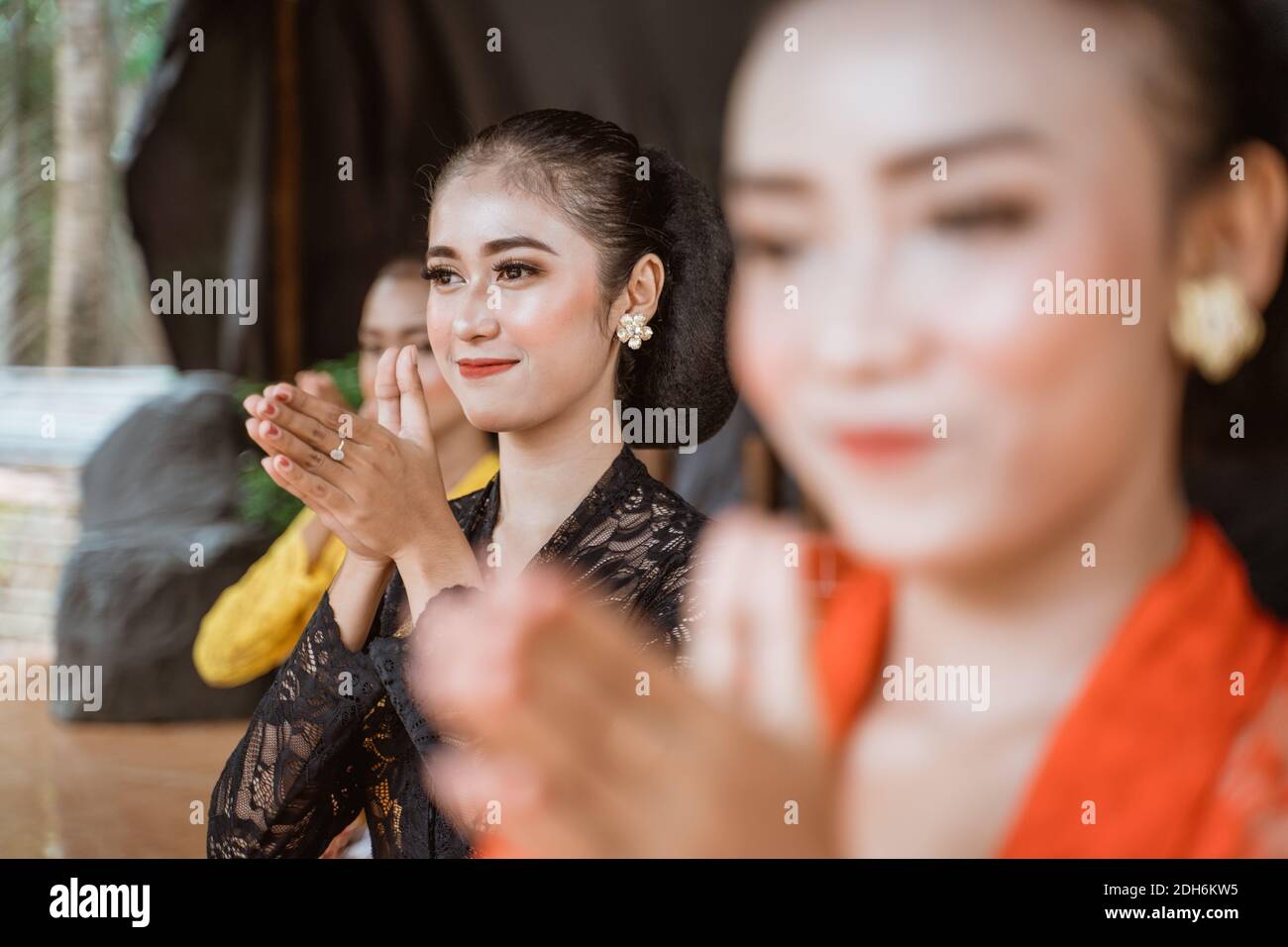 portrait of three young women presenting traditional Javanese dance ...